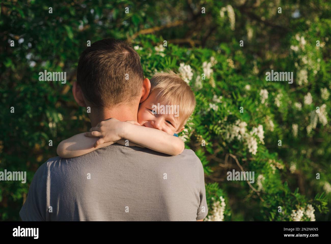 Father's Day. Father and son are playing and hugging on a green ...