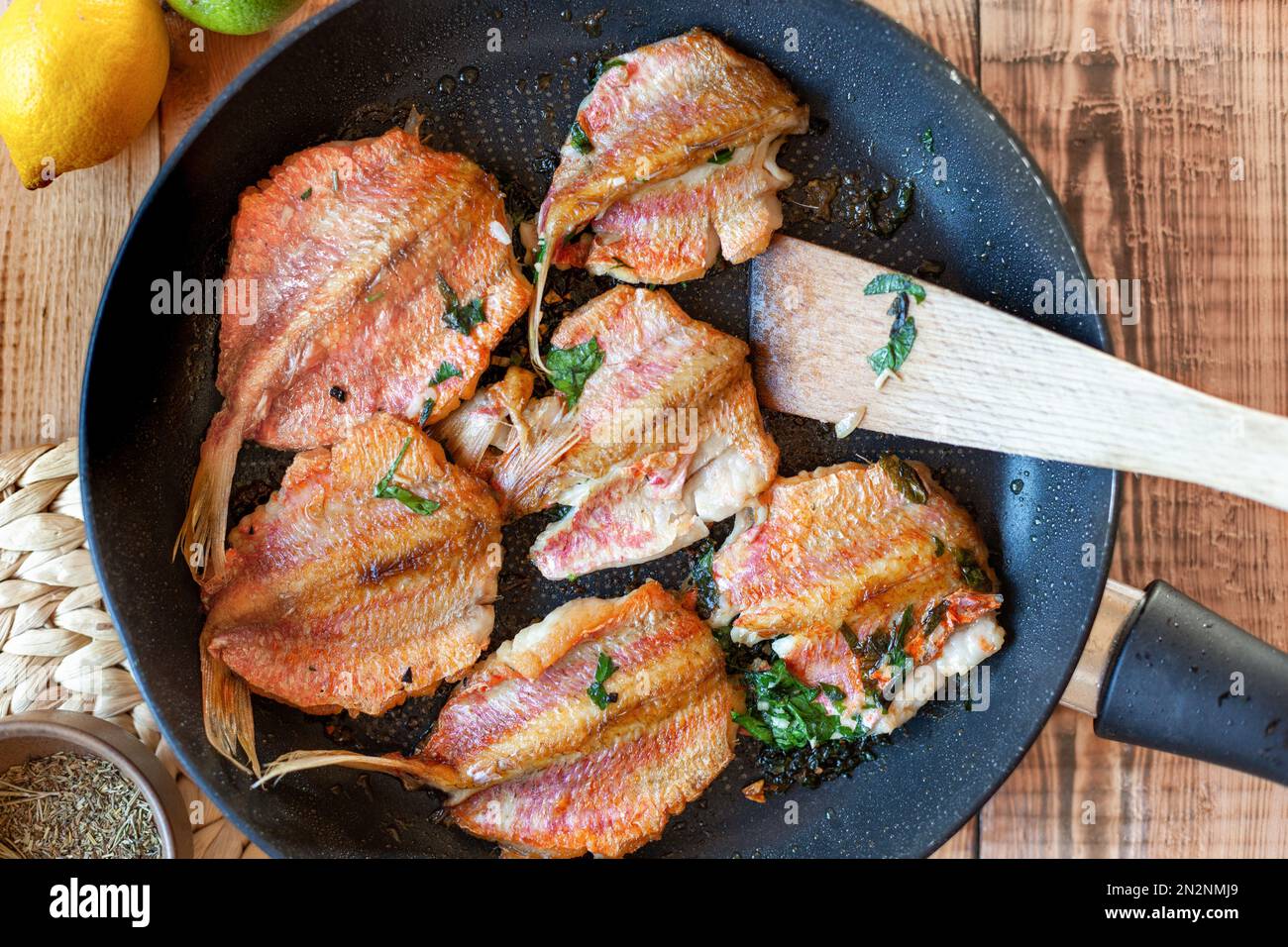 red mullet fish cooked on a pan, side view, top view Stock Photo - Alamy