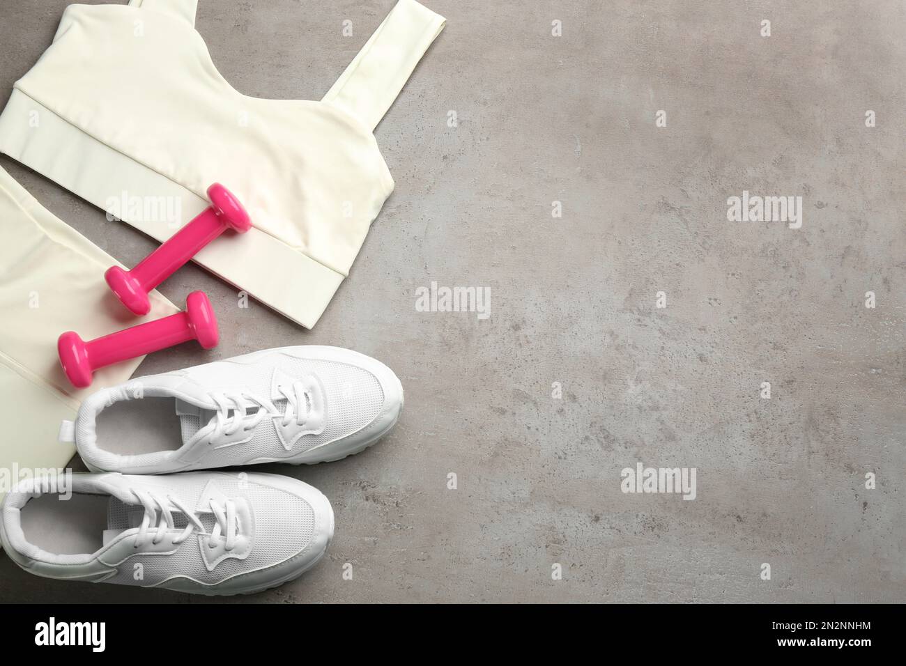 Flat lay composition with sportswear and equipment on grey table, space ...