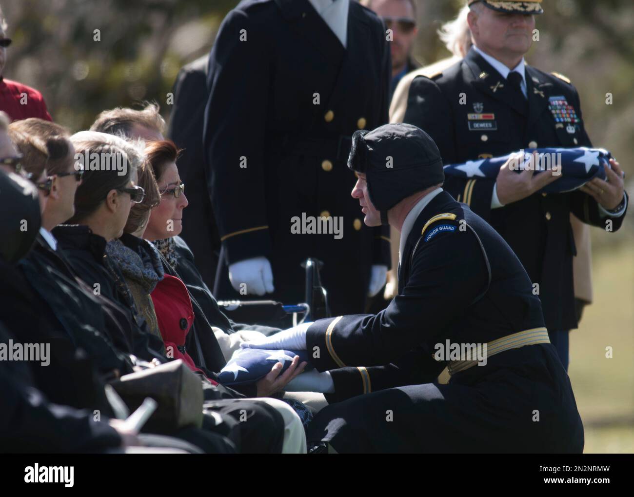 Army Lt. Col. David Taylor presents a flag to Taina Copeland, the ...