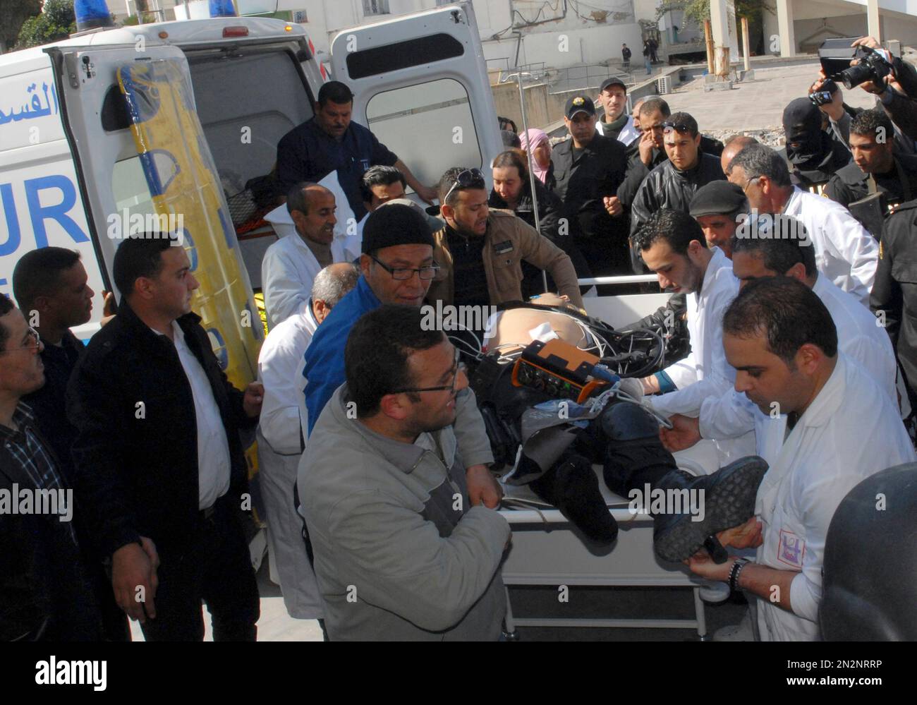 A wounded police officer arrives on a stretcher at the Charles Nicoles ...