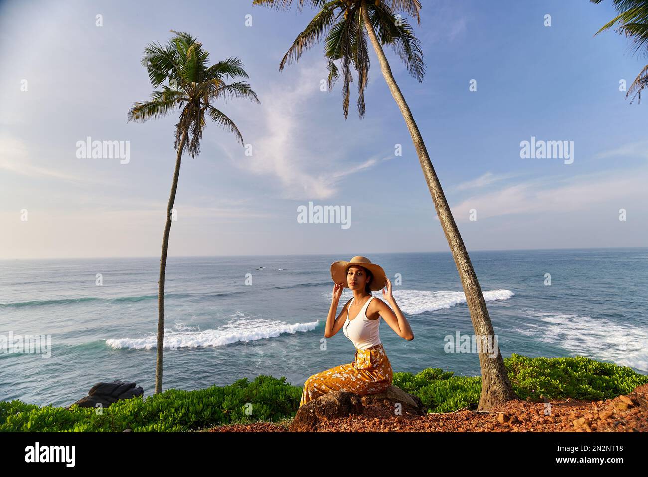 Young african female model posing in colorful clothes at scenic ...