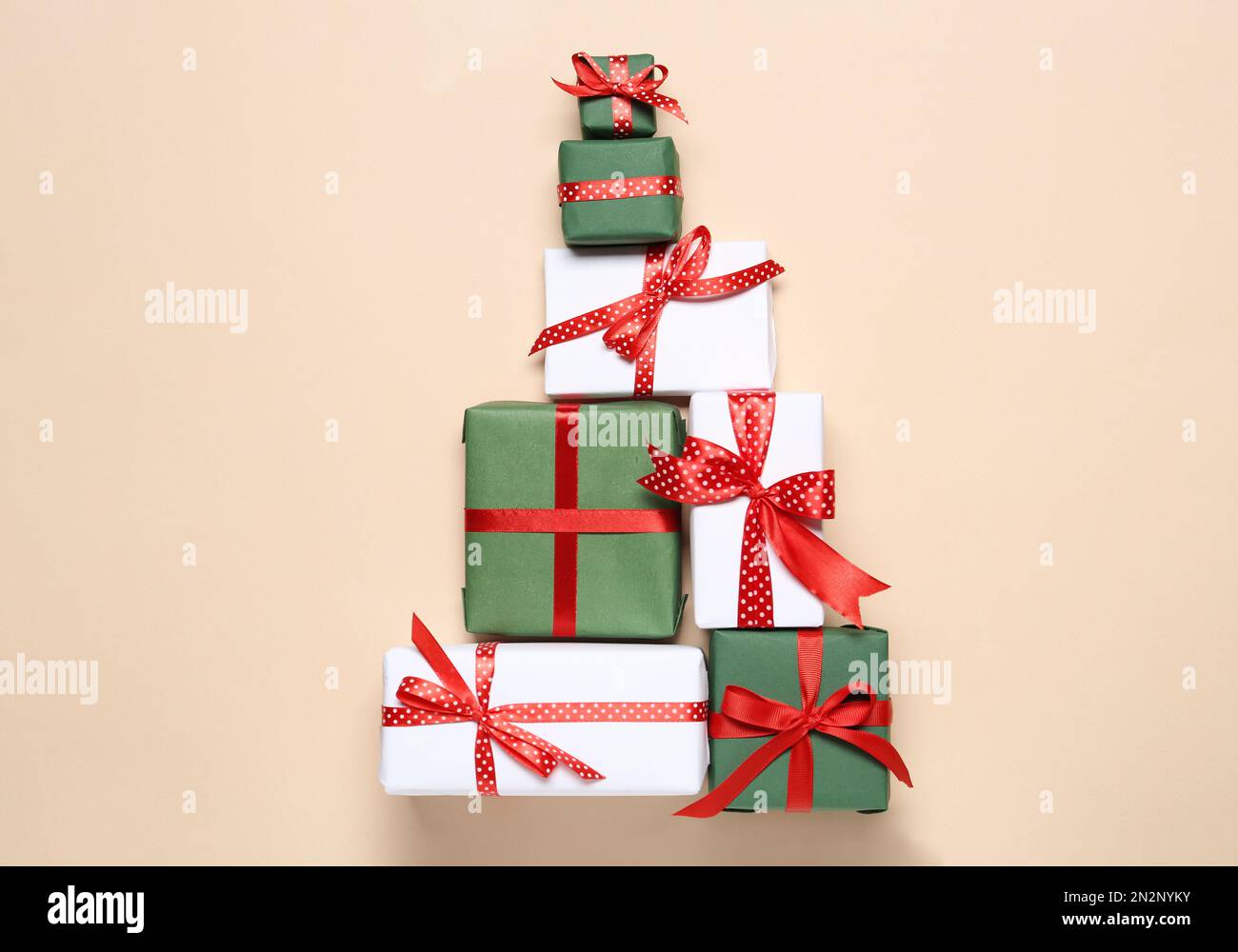 Christmas tree shape of gift boxes on beige background, flat lay Stock ...