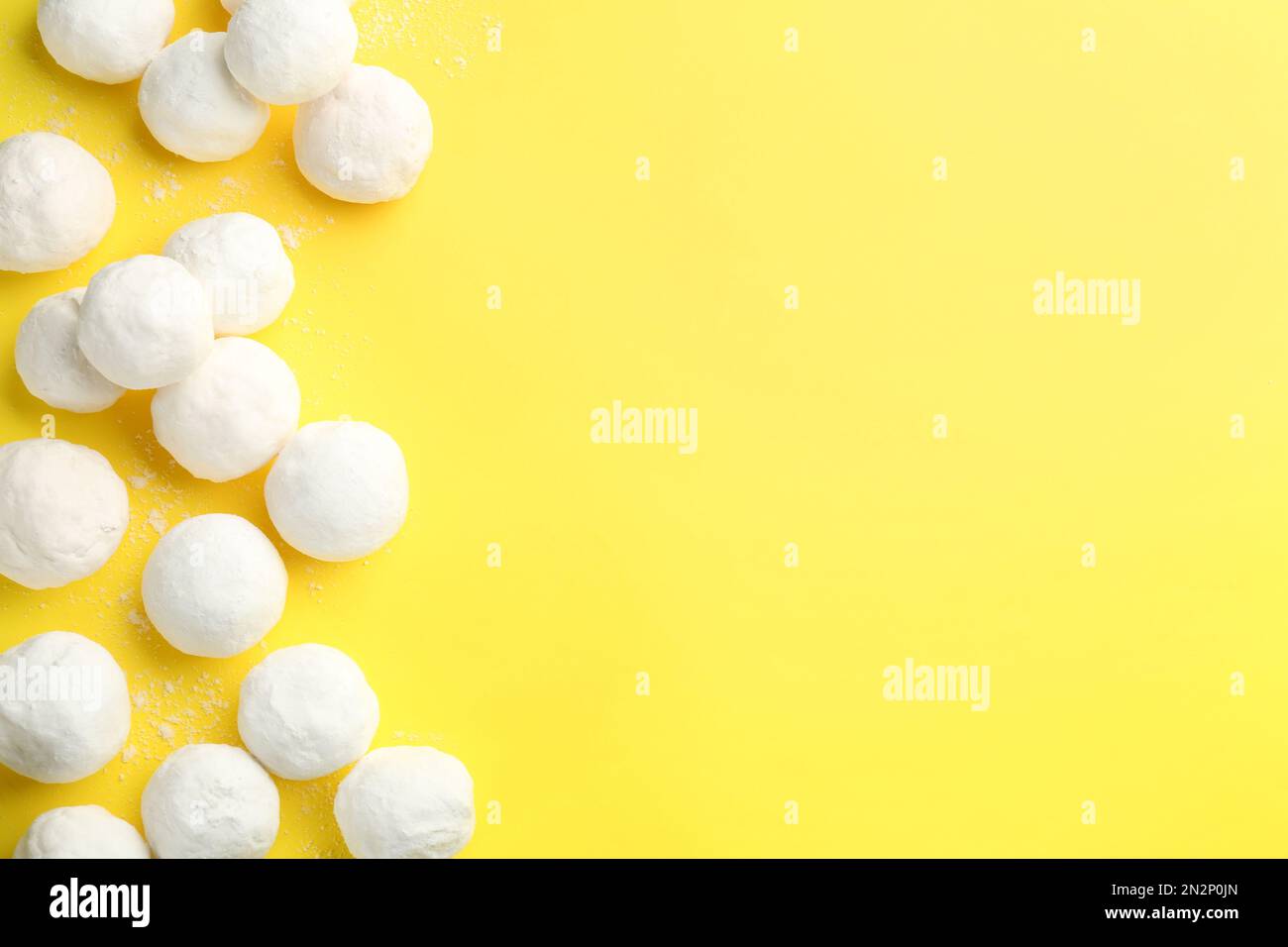 Snowballs on yellow background, flat lay. Space for text Stock Photo ...