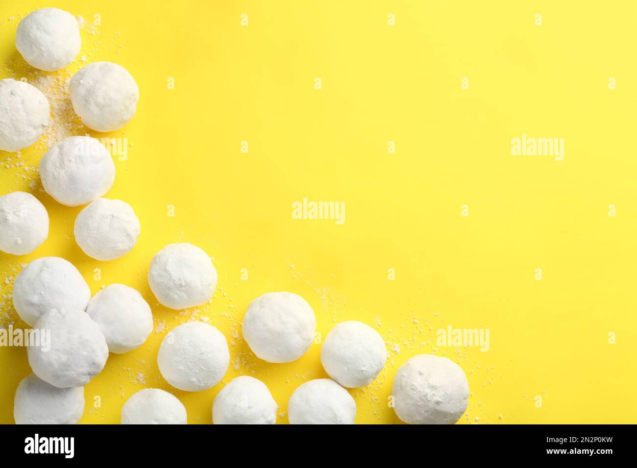 Snowballs on yellow background, flat lay. Space for text Stock Photo ...