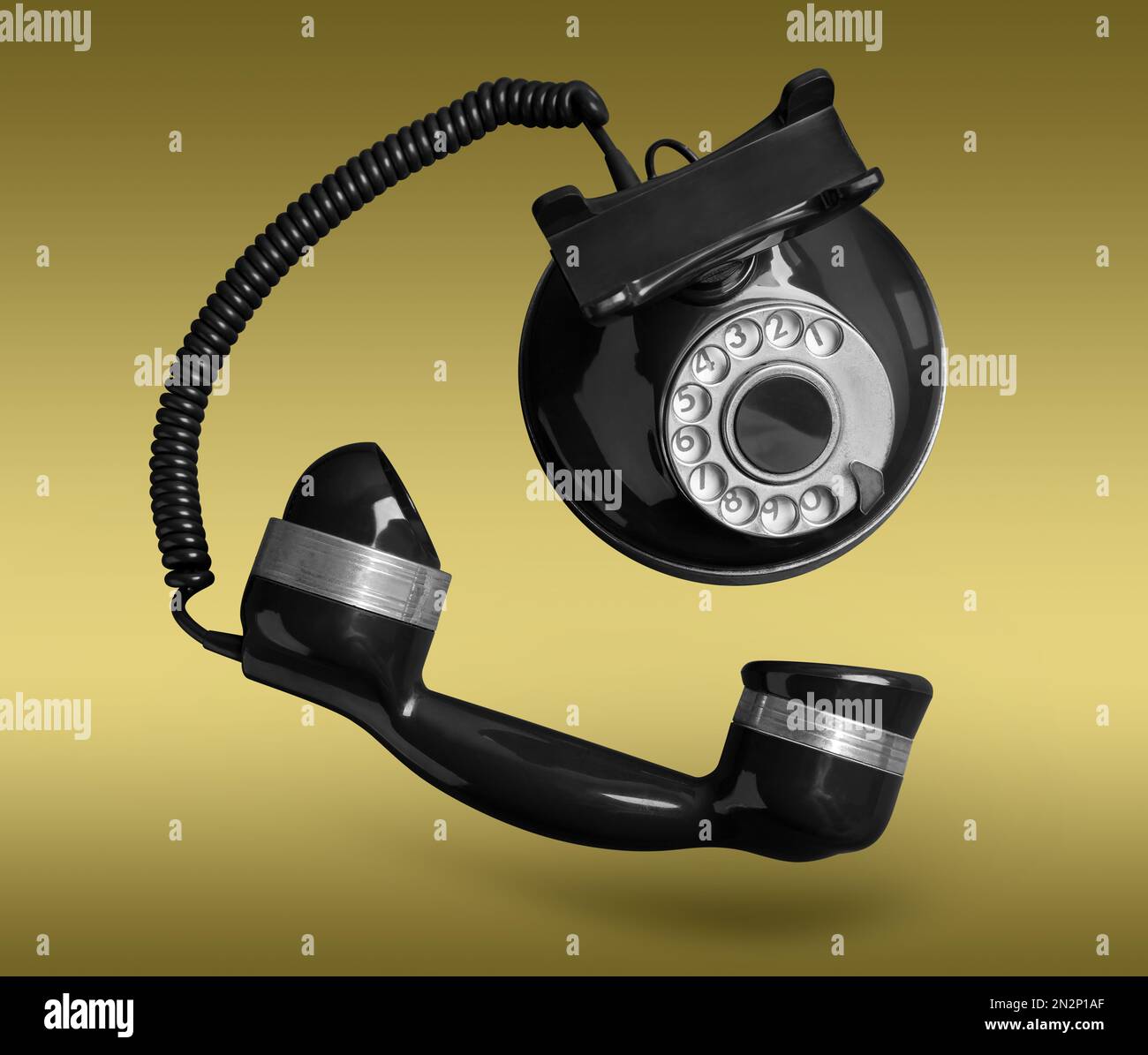 Vintage black corded telephone flying in air on color background Stock ...