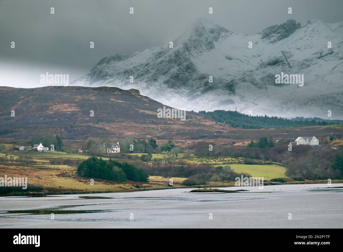 Scotland, Isle of Skye, village scene in winter with white crofters ...