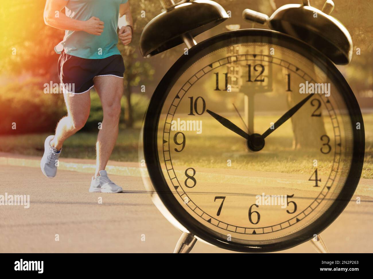 Time to do morning exercises. Double exposure of man running in park ...