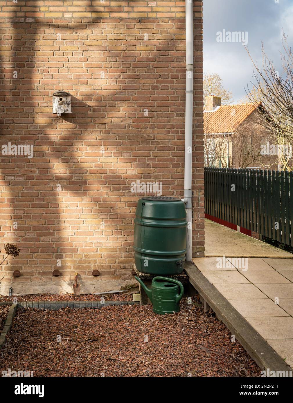 Rain barrel connected to the gutter, rain water harvesting and reusage ...