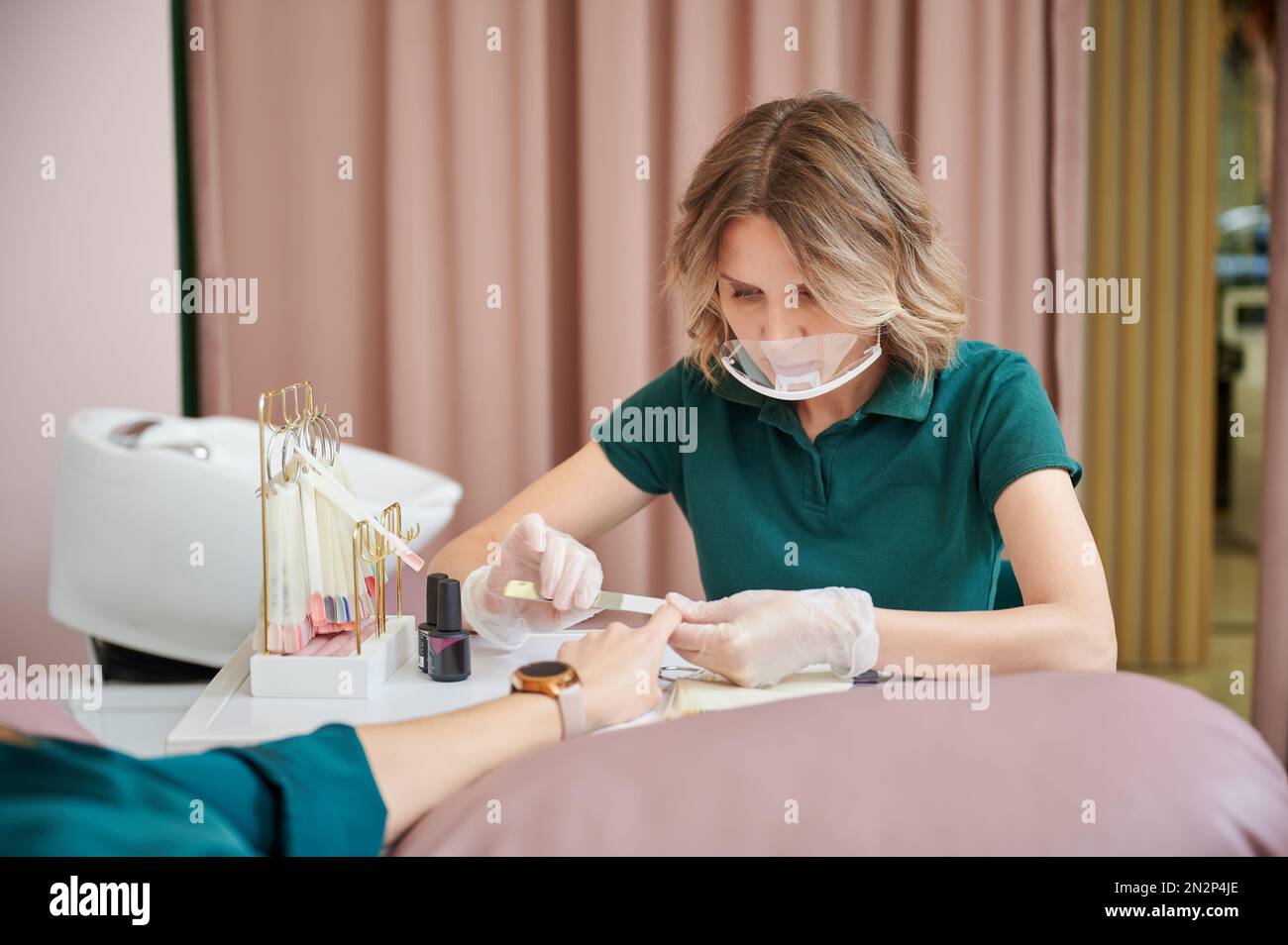 Manicure master doing filing nails hi-res stock photography and images ...