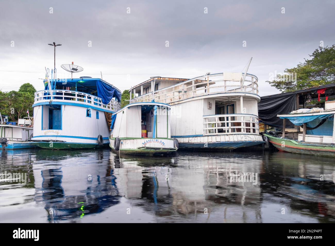 Traditional wooden Amazon river boats moored in Barcelos, Brazil ...