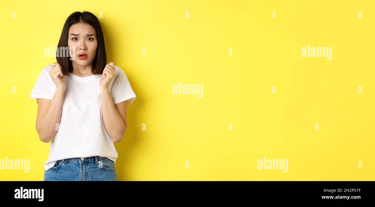 Beauty and fashion concept. Scared timid asian girl looking anxious ...