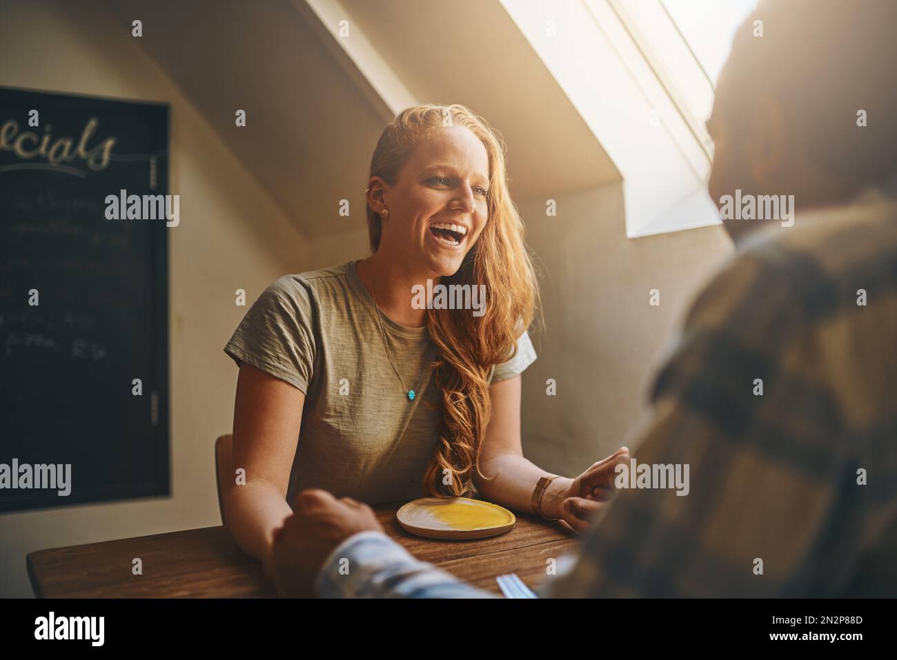 Date, happy and woman laugh at joke at lunch in a cafe or restaurant ...