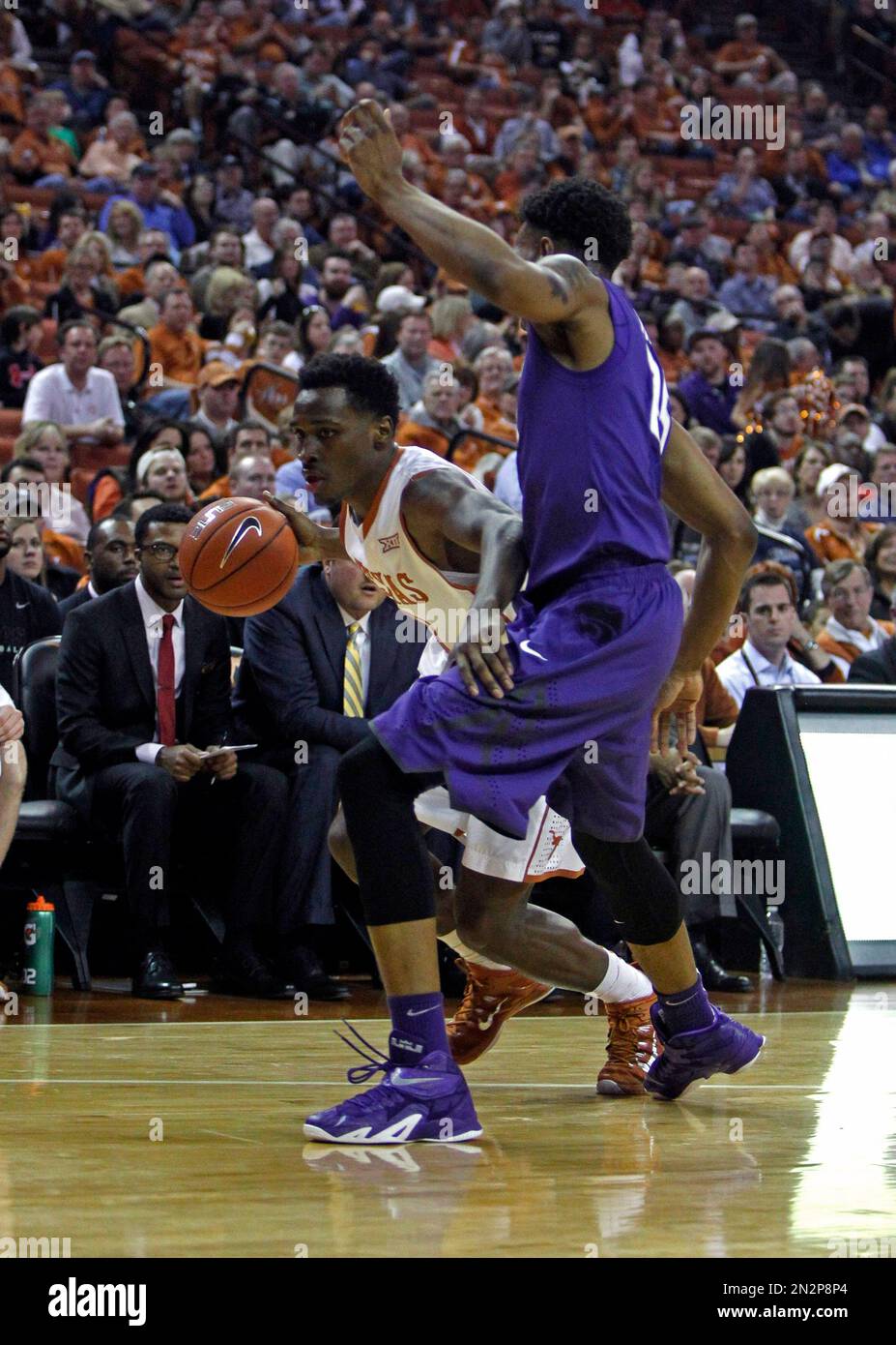Texas guard Kendal Yancy, left, drives around Kansas State guard Justin ...