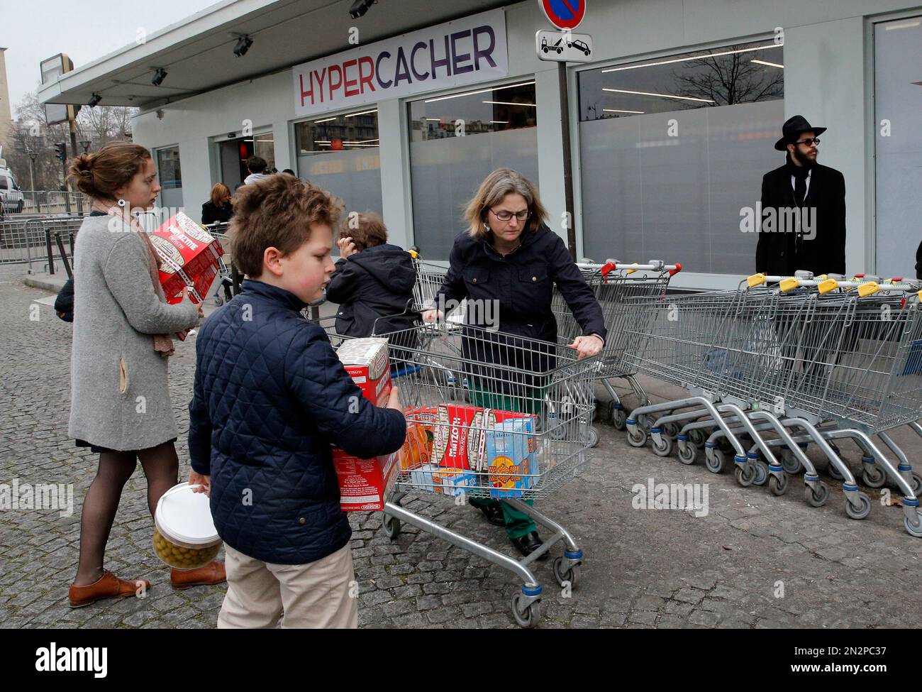 Customers leave the Hyper Cacher with their shopping, on the store's ...