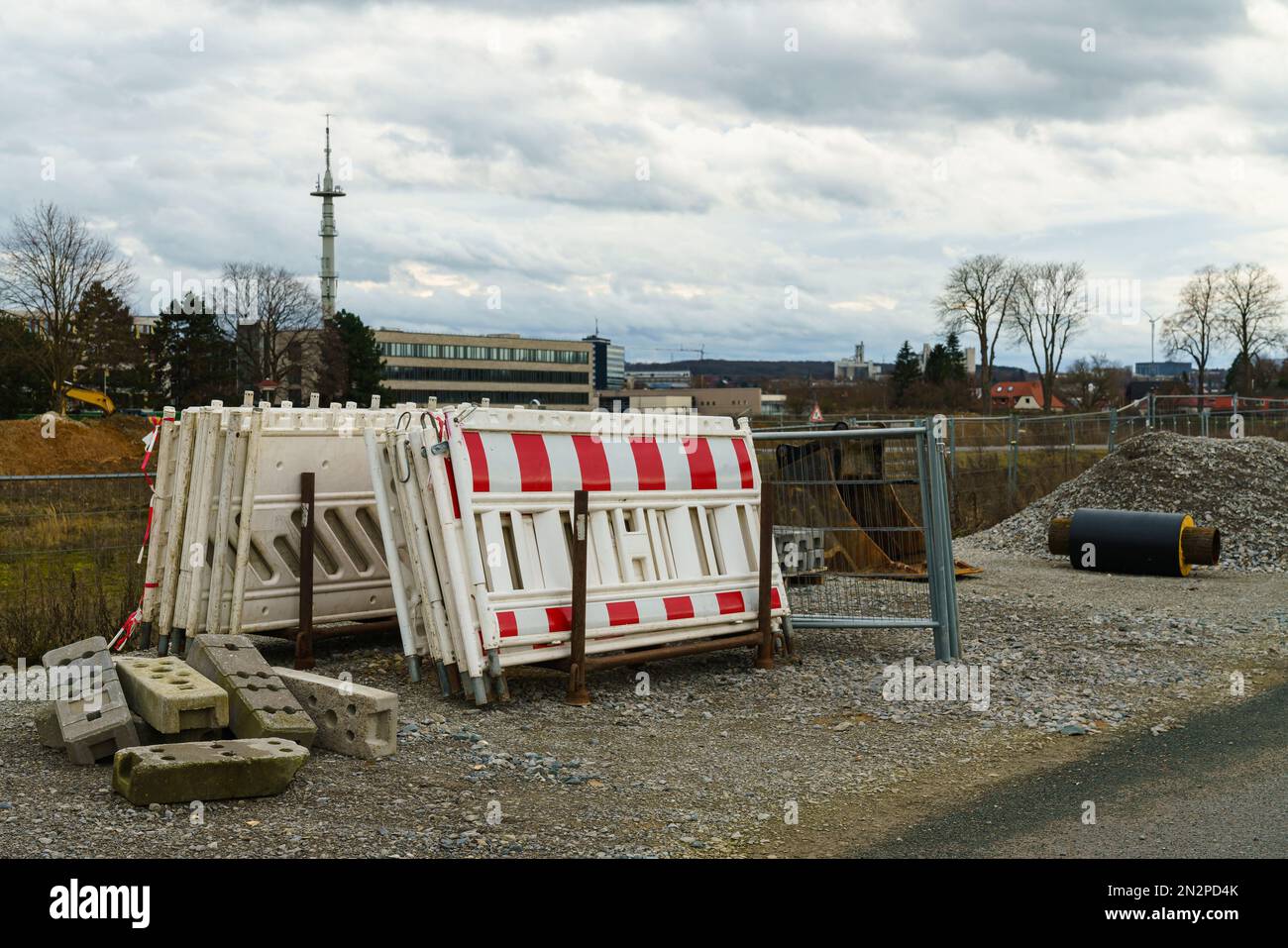 White and red plastic fencing at a construction site next to an ...