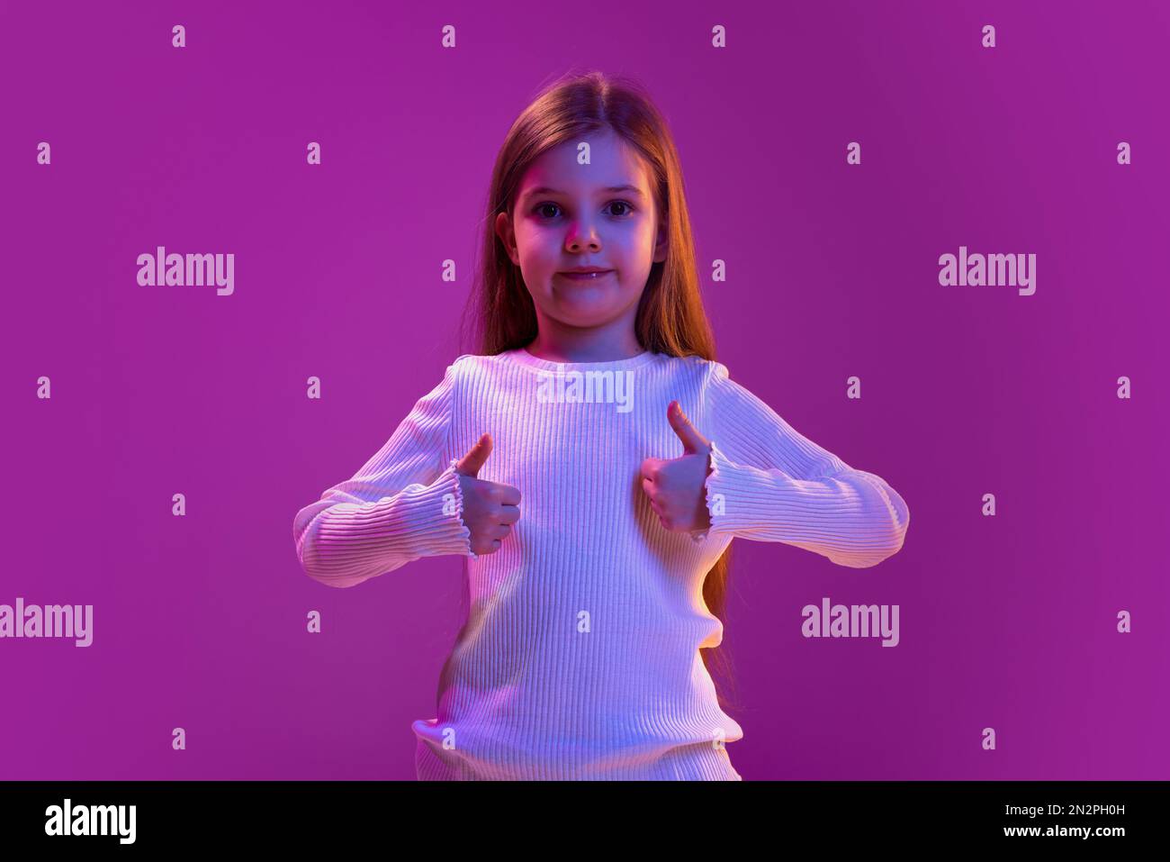 Fingers up. Portrait of little girl, child in casual clothes posing ...