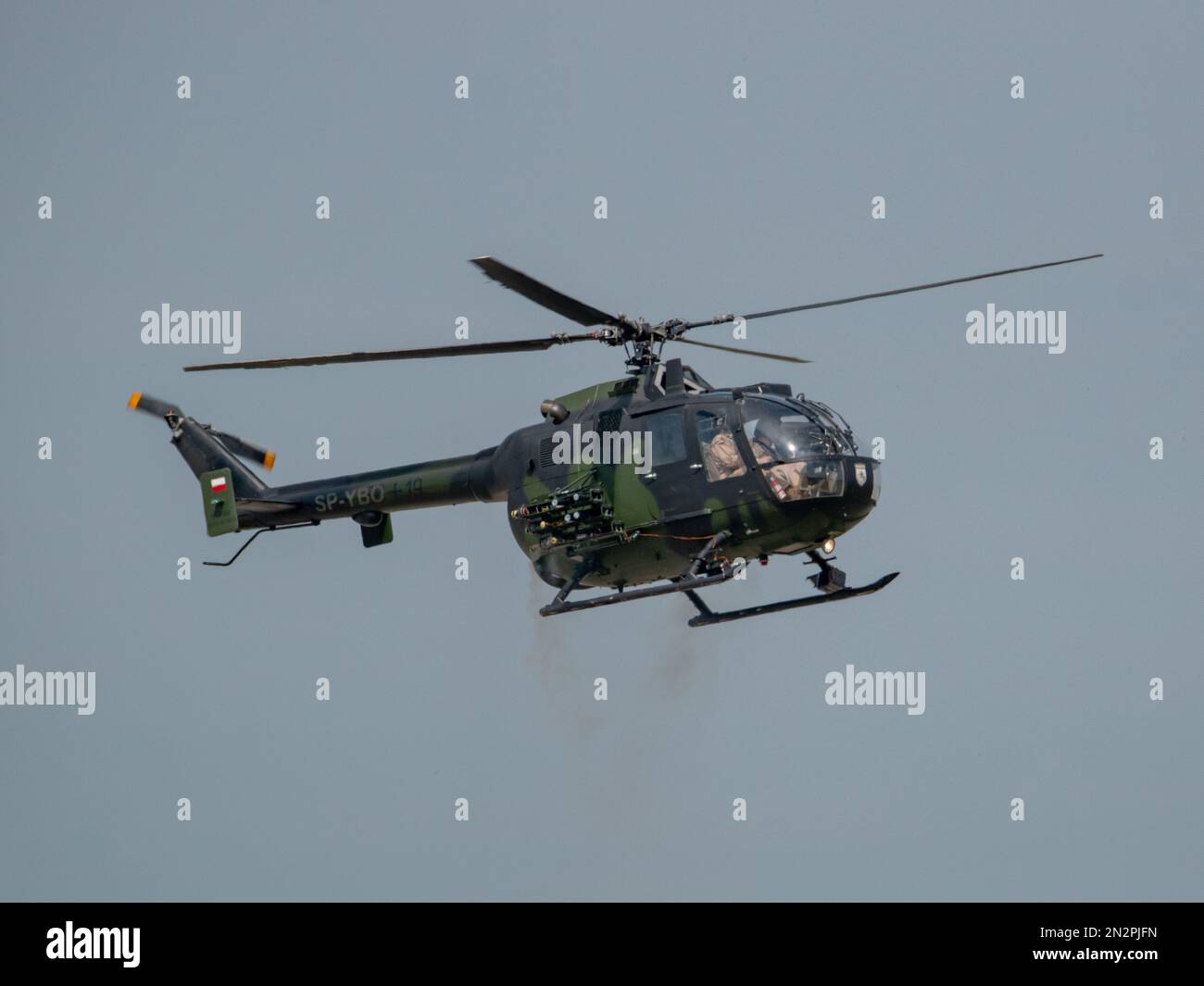 A closeup of MBB Bo105 helicopter flying in the sky at an air show in ...