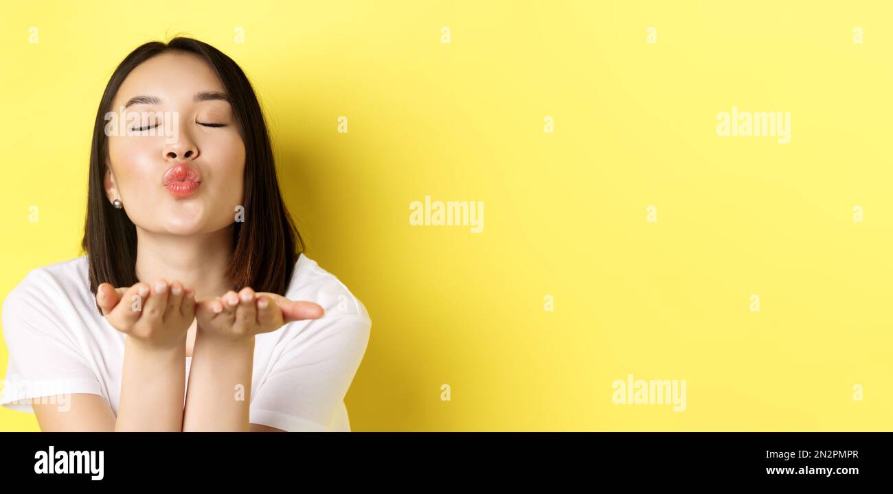 Valentines day concept. Close up of beautiful asian woman pucker lips ...