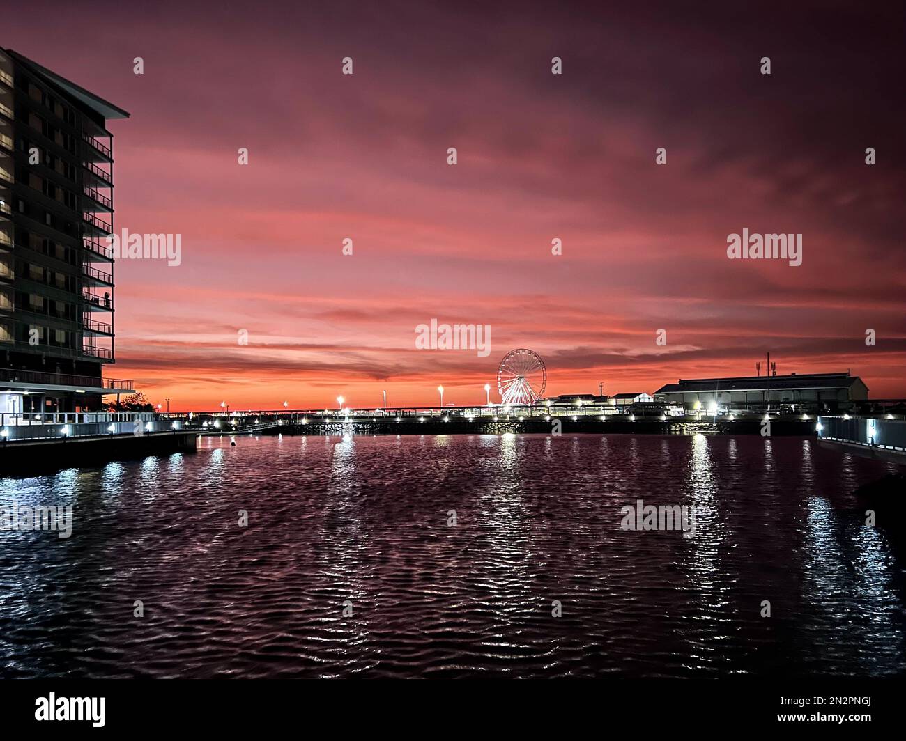 Sunrise over Ferris Wheel, Stokes Hill Wharf and Kitchener Bay, Darwin ...
