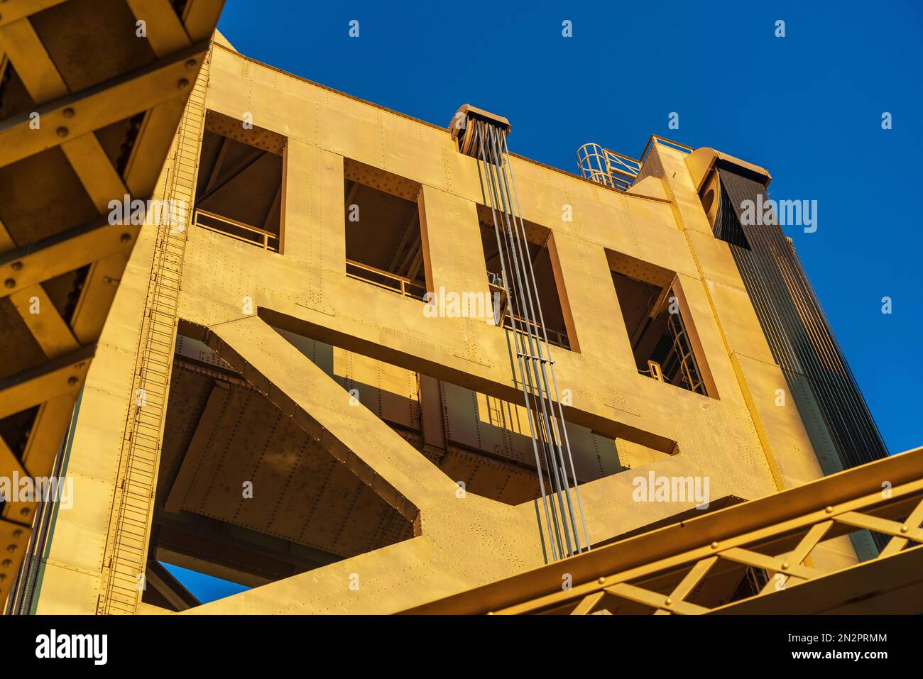 A low angle shot of the yellow steel Sacramento's Tower Bridge at ...