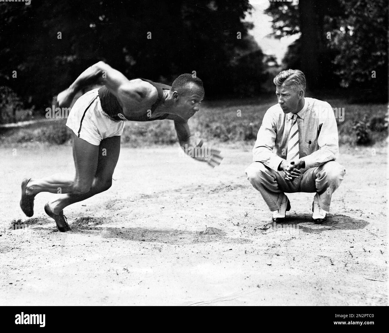 Sprinter Jesse Owens is shown practicing his starts in this undated ...