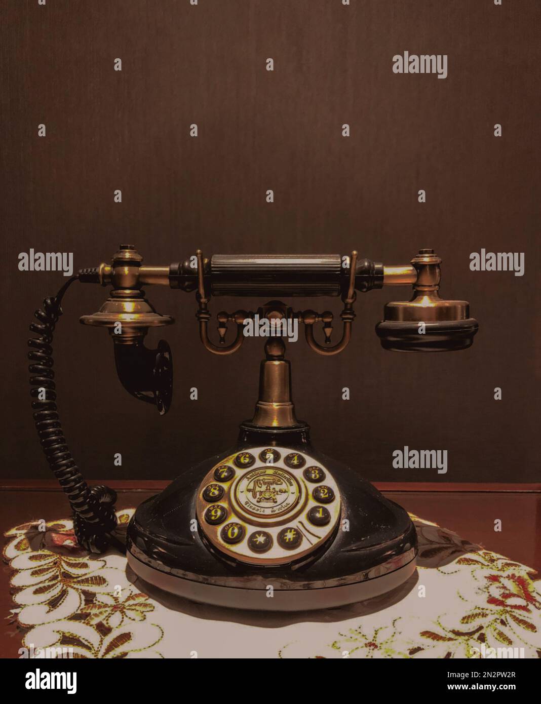 An vertical closeup of an old telephone in dim lighting in a luxury ...
