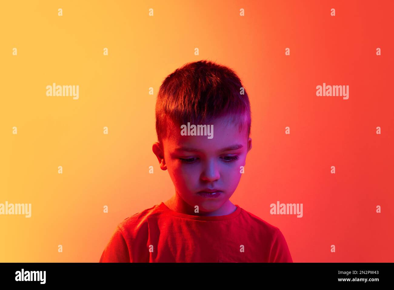 Feeling tired. Portrait of little boy, child posing with sad face over ...