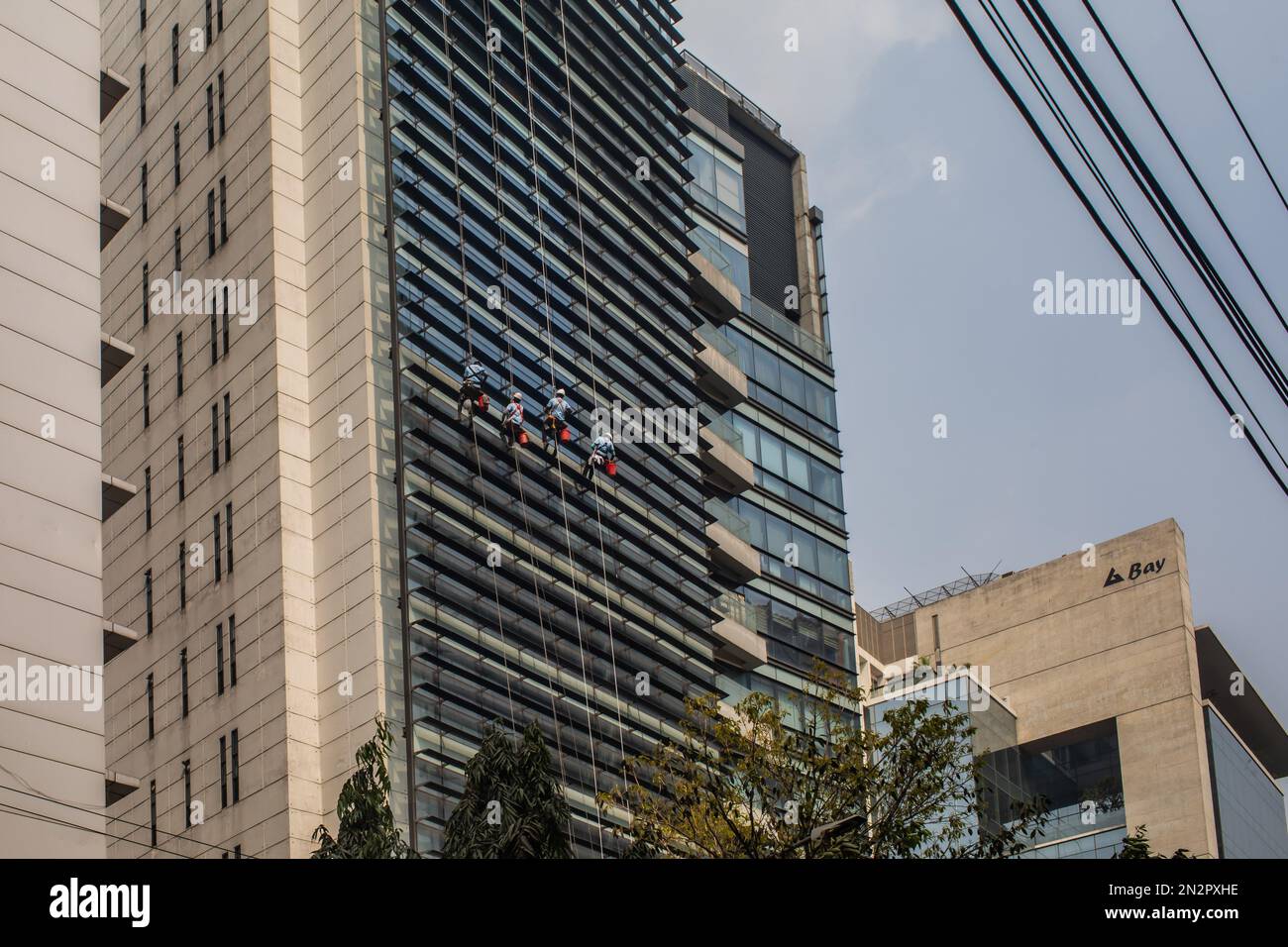 Dhaka, Bangladesh. 07th Feb, 2023. Workers clean a wall of a high-rise ...