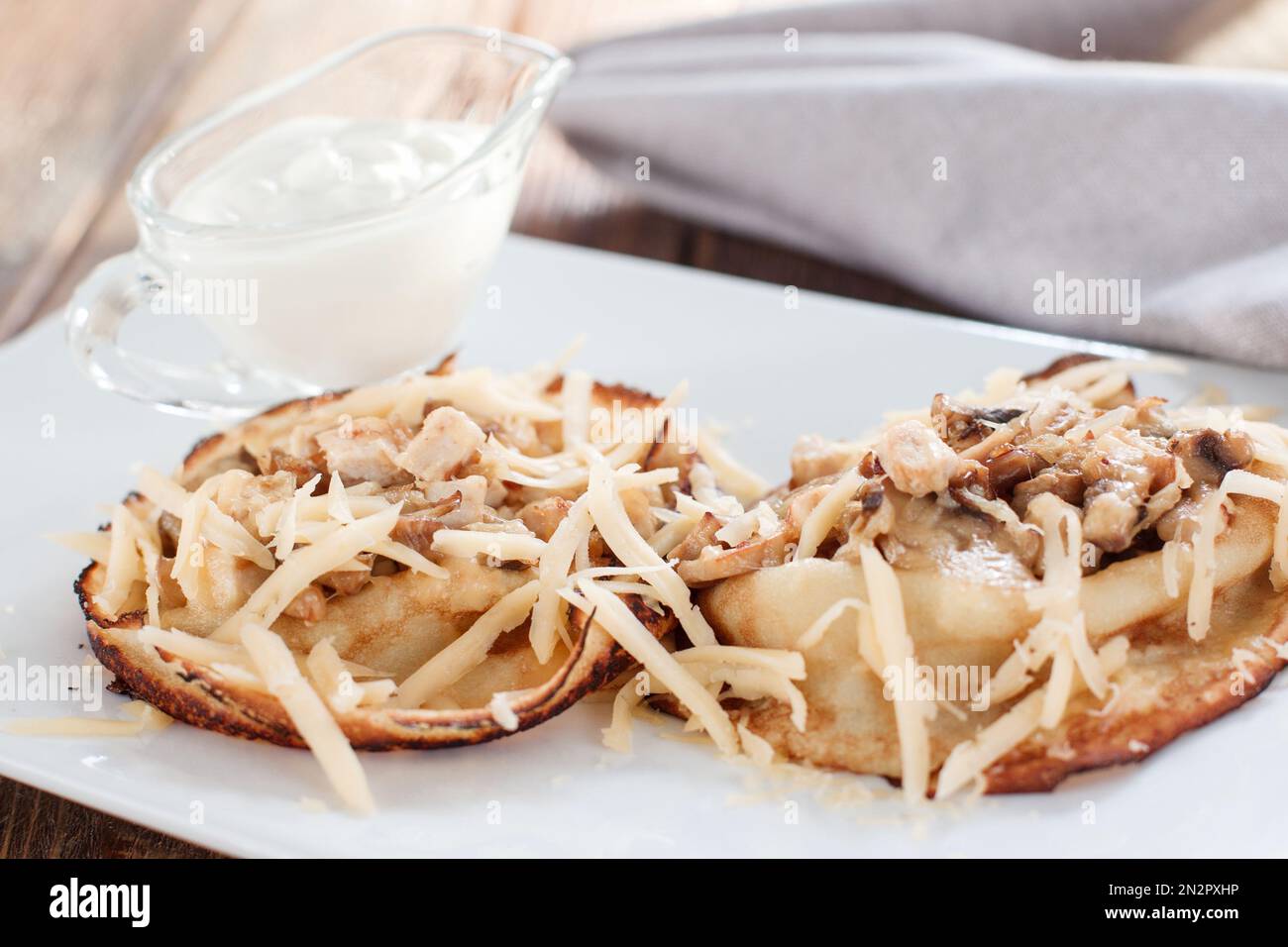 Restaurant serving of crepes with cheese and meat Stock Photo - Alamy