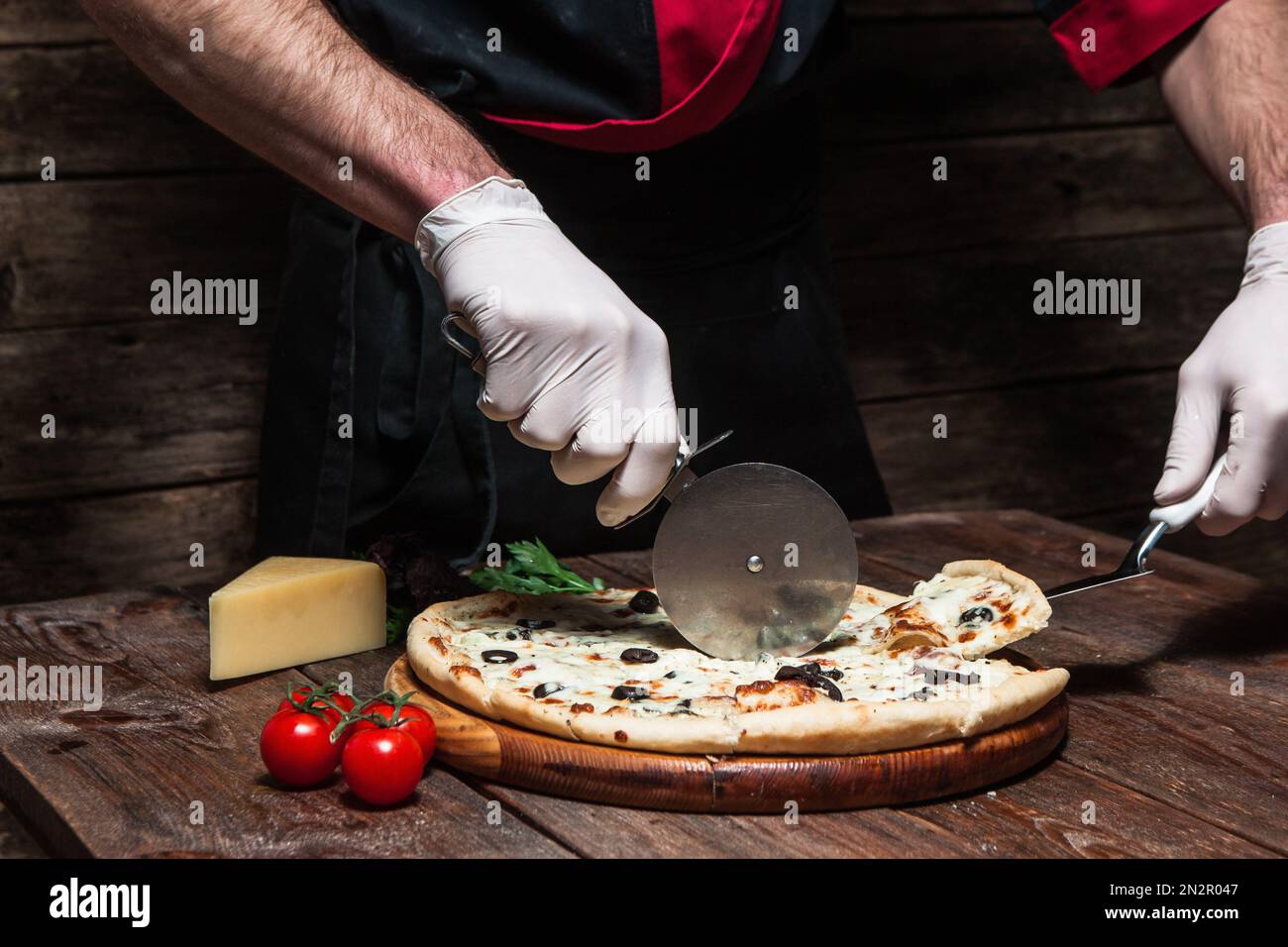 Preparing italian pizza by professional pizzaiolo Stock Photo - Alamy