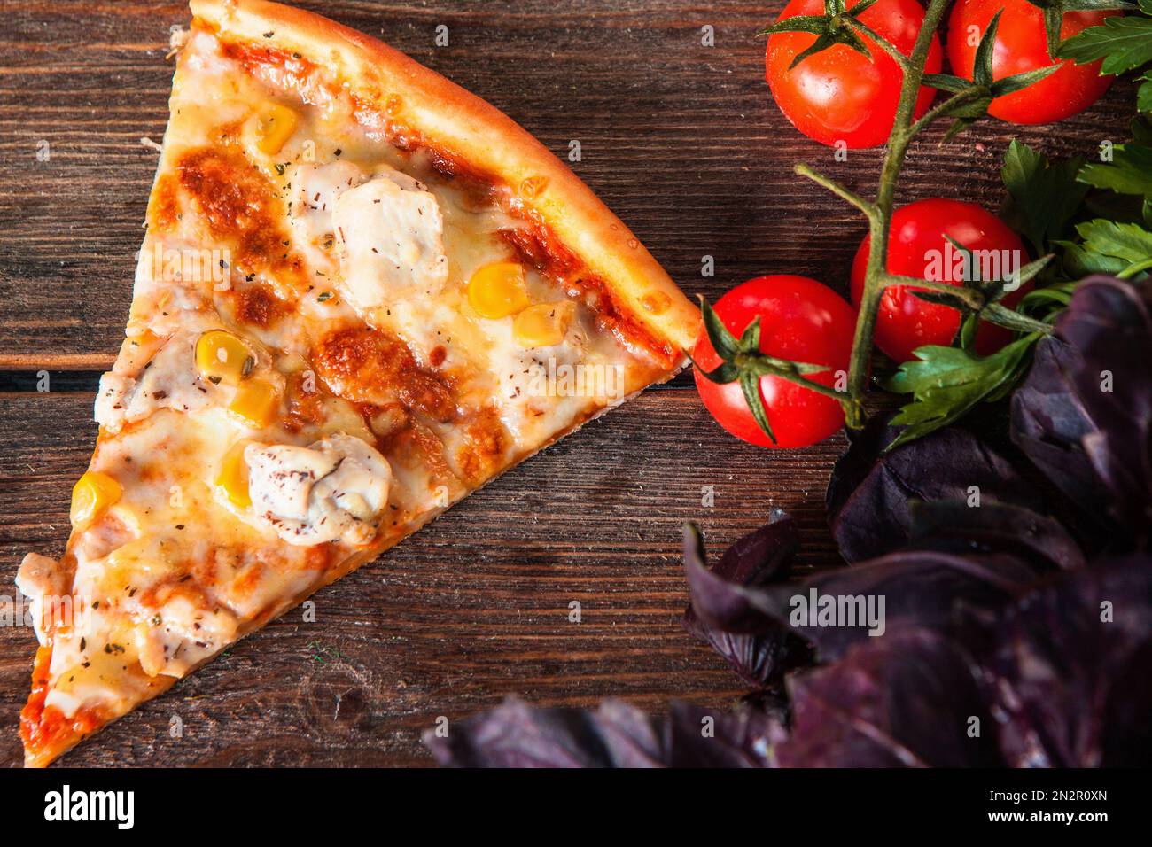 Slice of hot pizza on wood table. Food background Stock Photo - Alamy