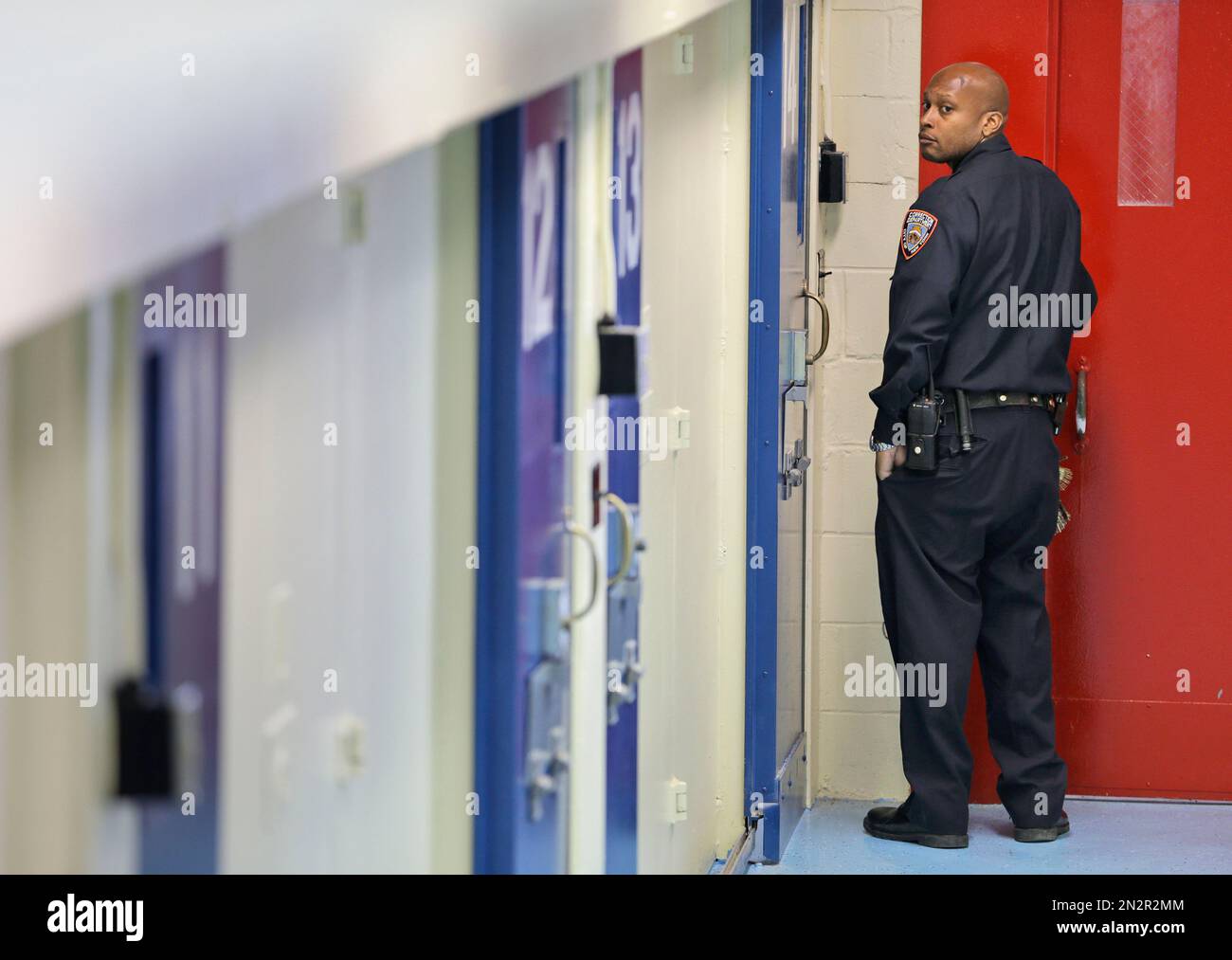 A corrections officers prepares for a news conference in an enhanced ...