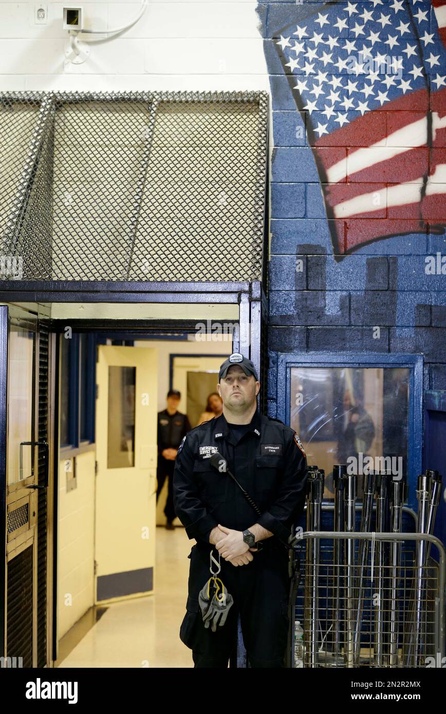 A corrections officer listens to a news conference in an enhanced ...
