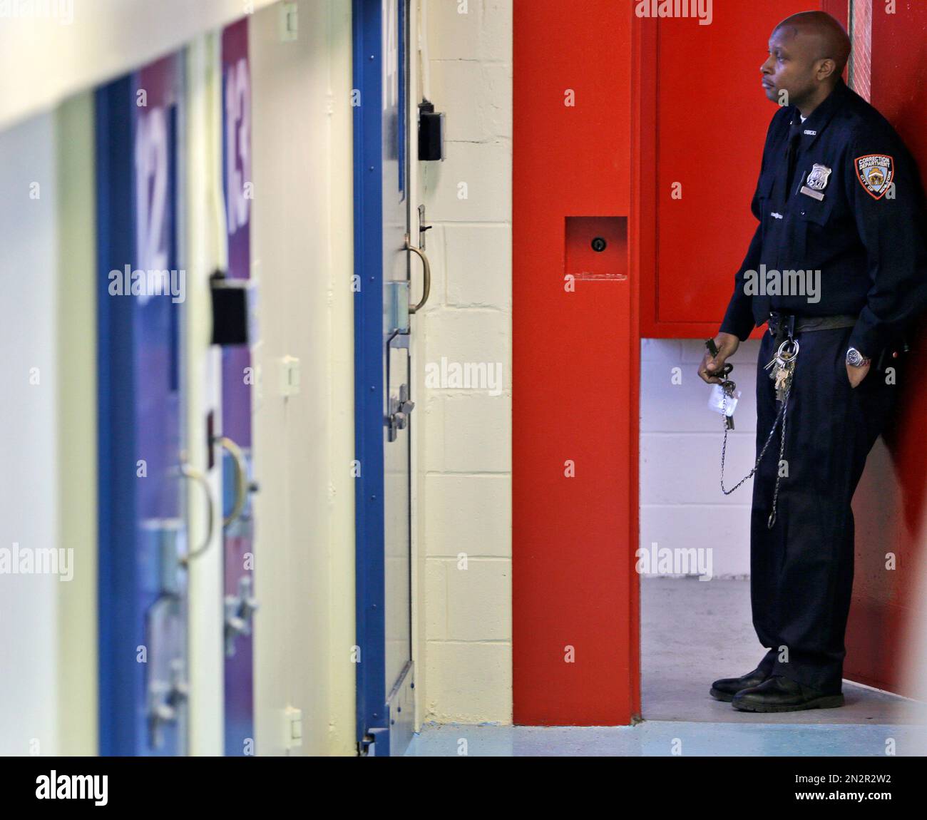 A corrections officers prepares for a news conference in an enhanced ...