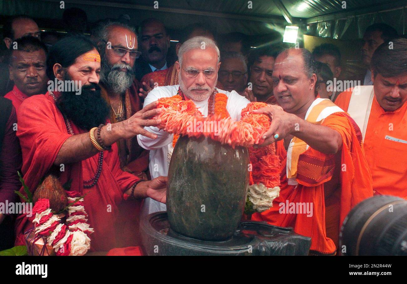 India's Prime Minister Narendra Modi, center, places flowers on a ...