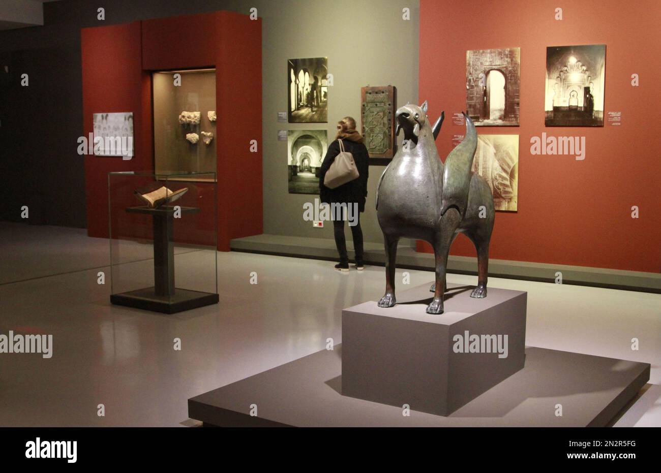 This March 4, 2015 photo shows a visitor examining photographs and ...