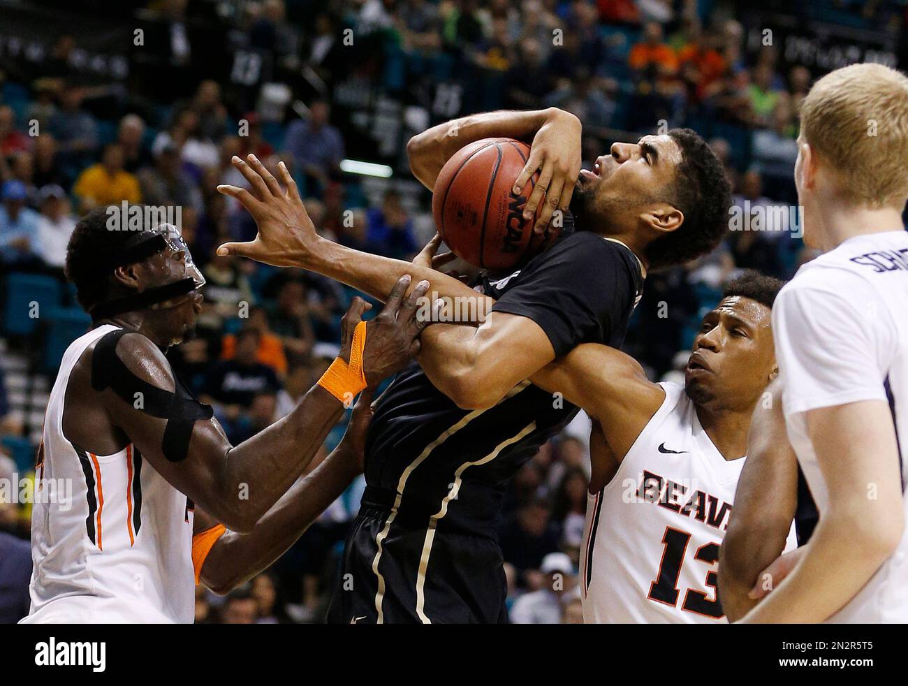 Colorado's Josh Scott, center, grabs a rebound over Oregon State's ...
