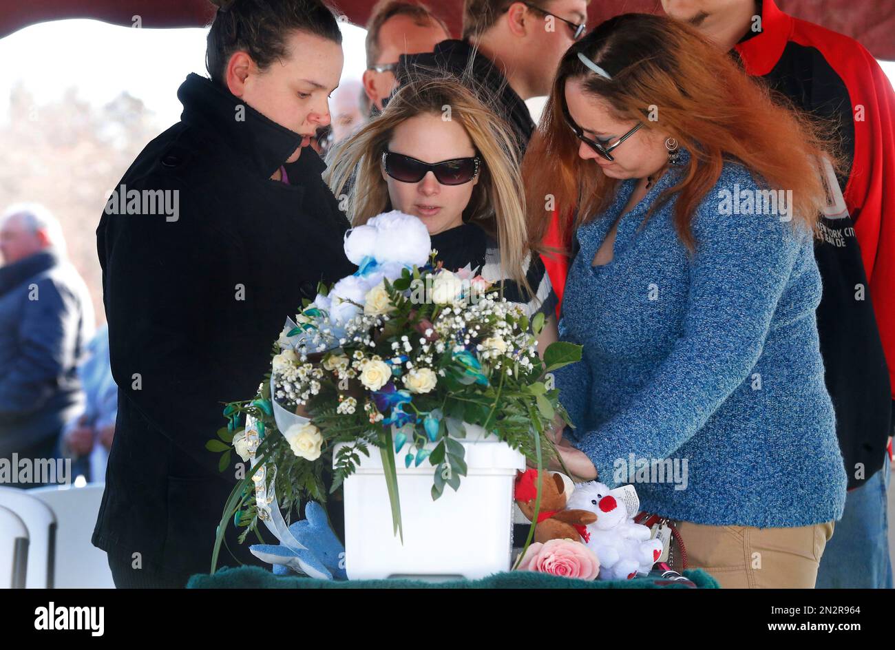 Mourners pay their respects at the casket of a newborn, known simply as ...