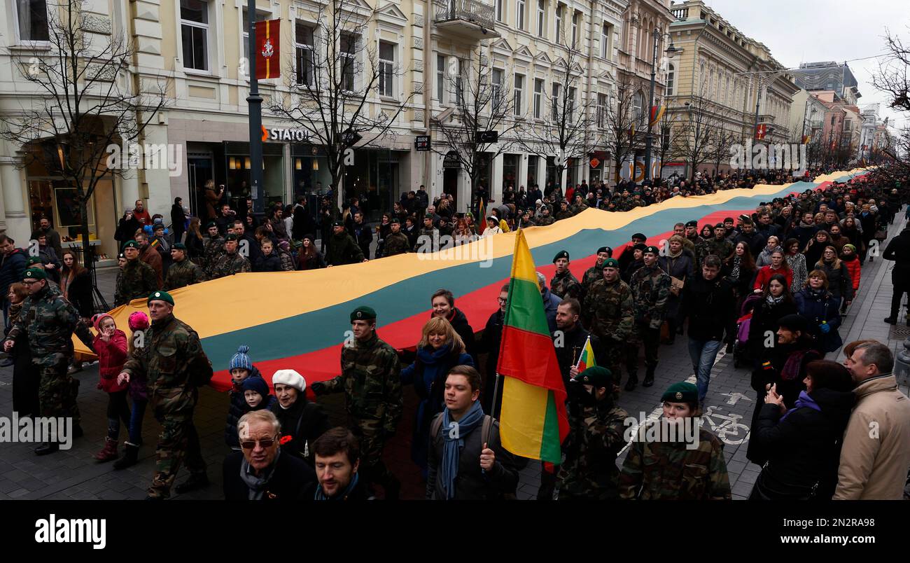 People carry a giant Lithuanian flag during a celebration of Lithuania ...