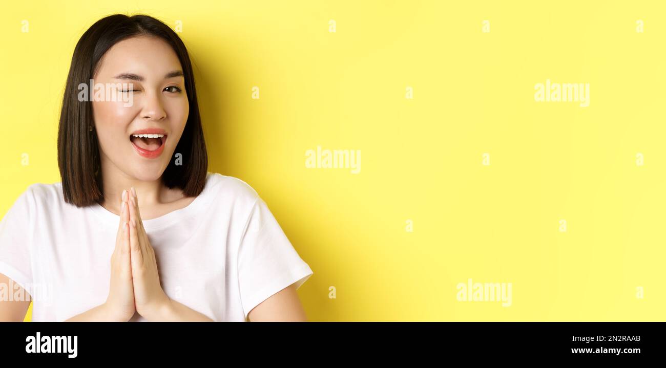 Cheerful cheeky woman yellow background hi-res stock photography and ...