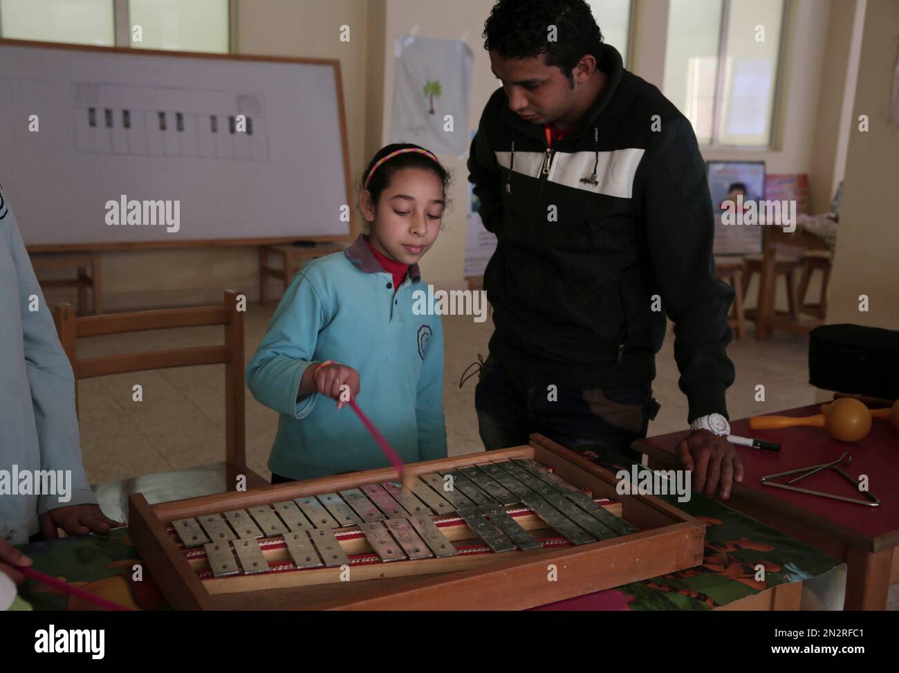 In this Wednesday, Feb. 25, 2015 photo, an Egyptian girl plays the ...