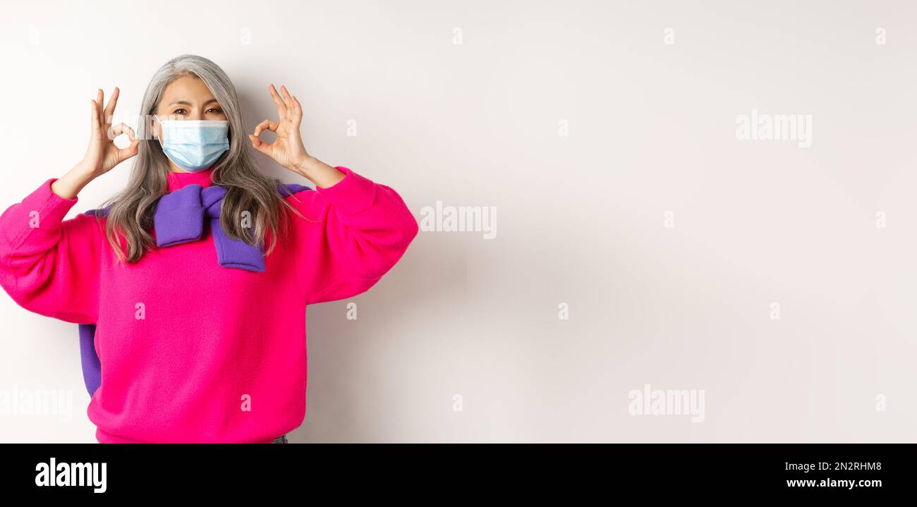 Covid-19, quarantine and lockdown concept. Fashionable asian old woman ...