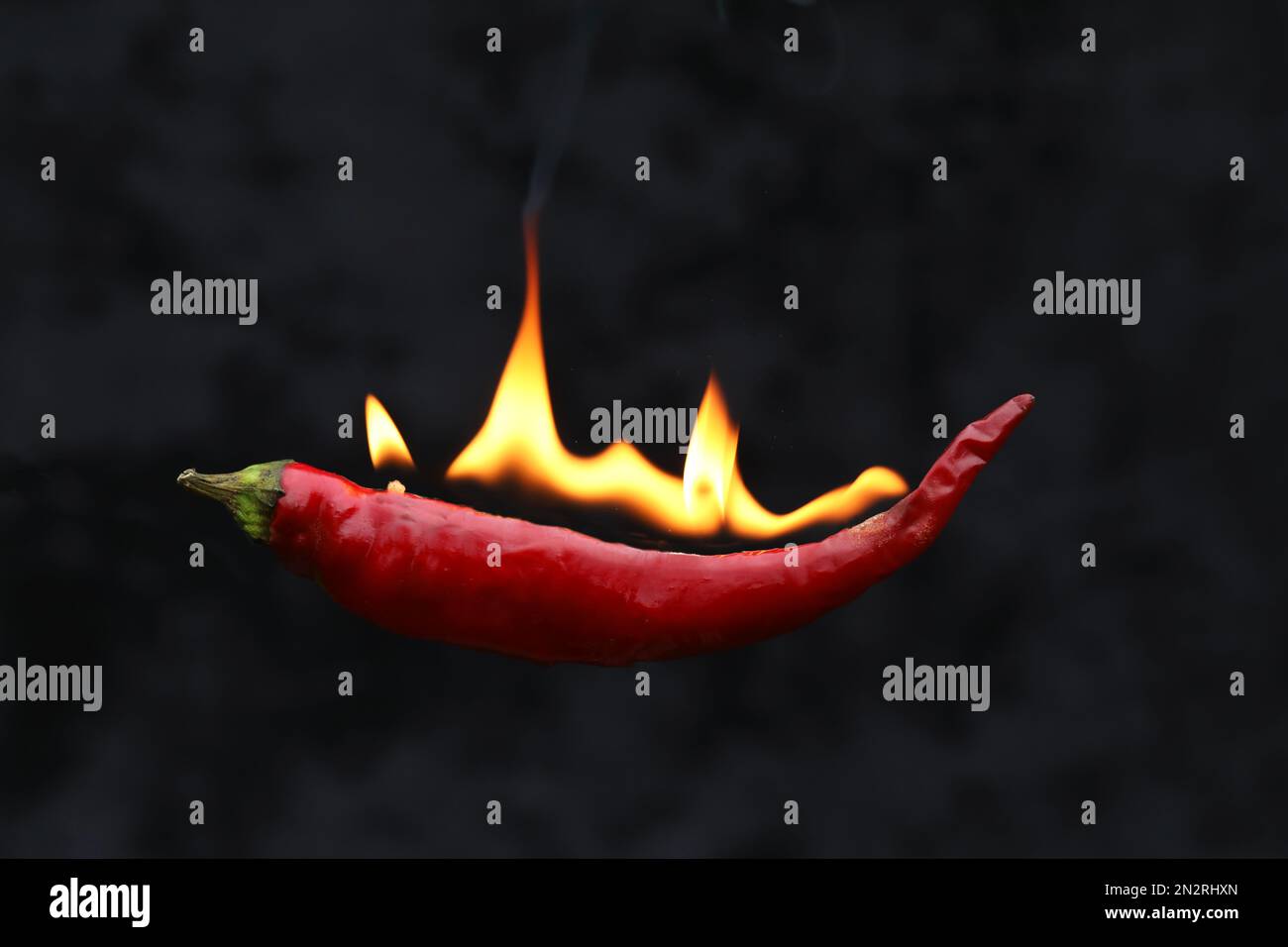 red hot chili pepper with a fire flame Stock Photo - Alamy