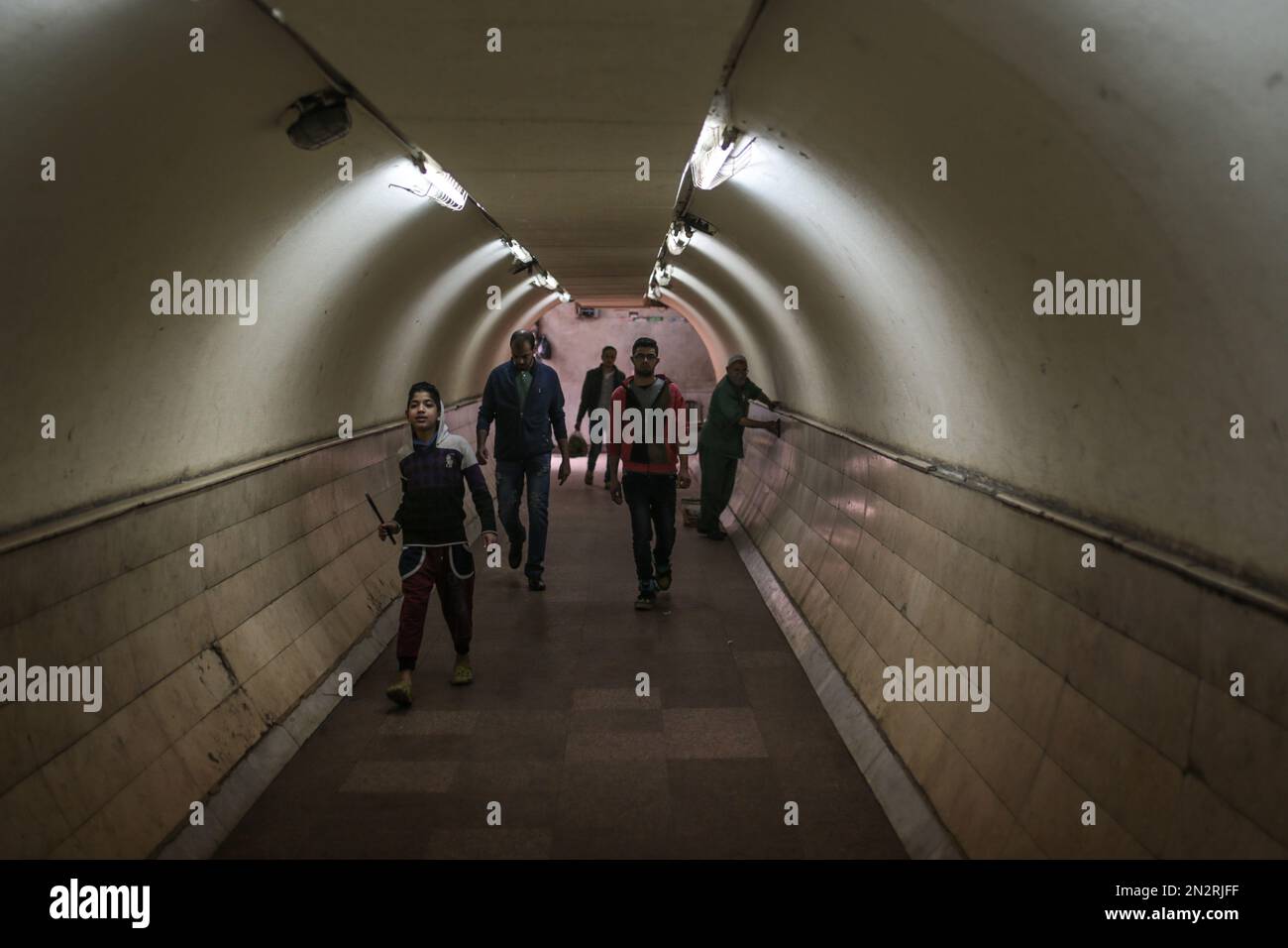 Egyptian cross a street through an underground tunnel in Islamic Cairo ...