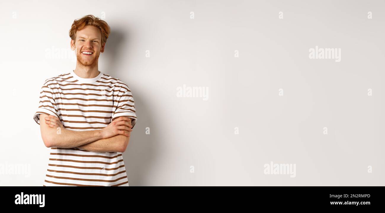 Happy redhead guy with bristle laughing and smiling at camera, standing ...