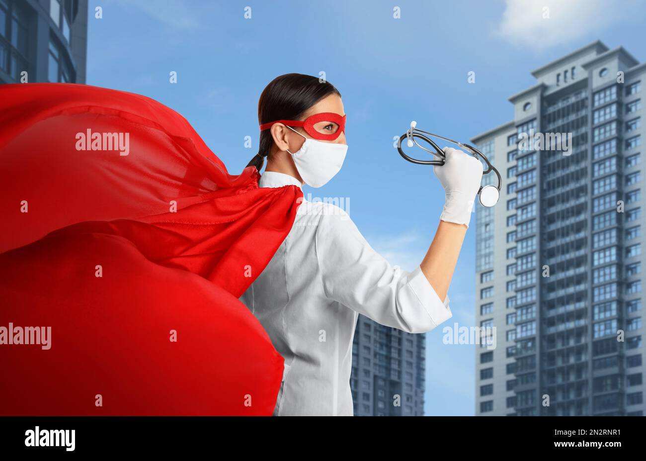 Doctor dressed as superhero on city background. Medical workers ...