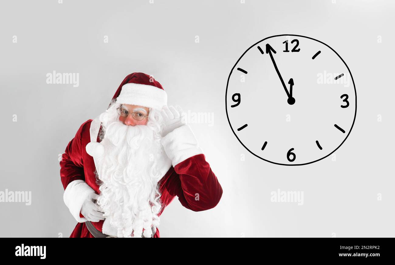 Christmas countdown. Clock showing five minutes to midnight near Santa ...