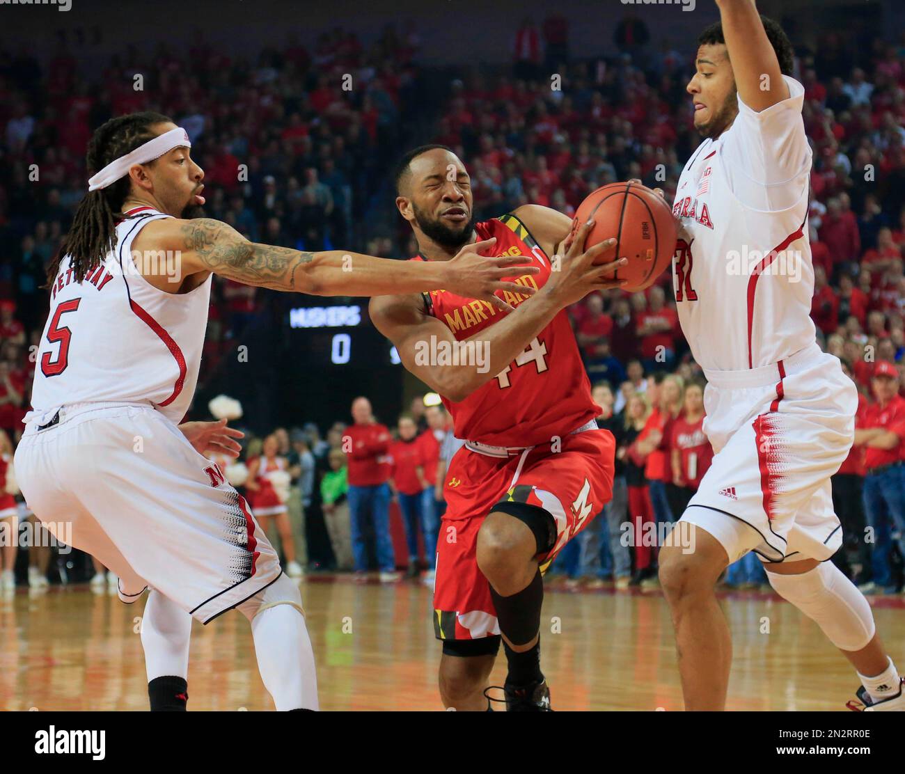 Maryland's Dez Wells (44) is defended by Nebraska forward Terran ...