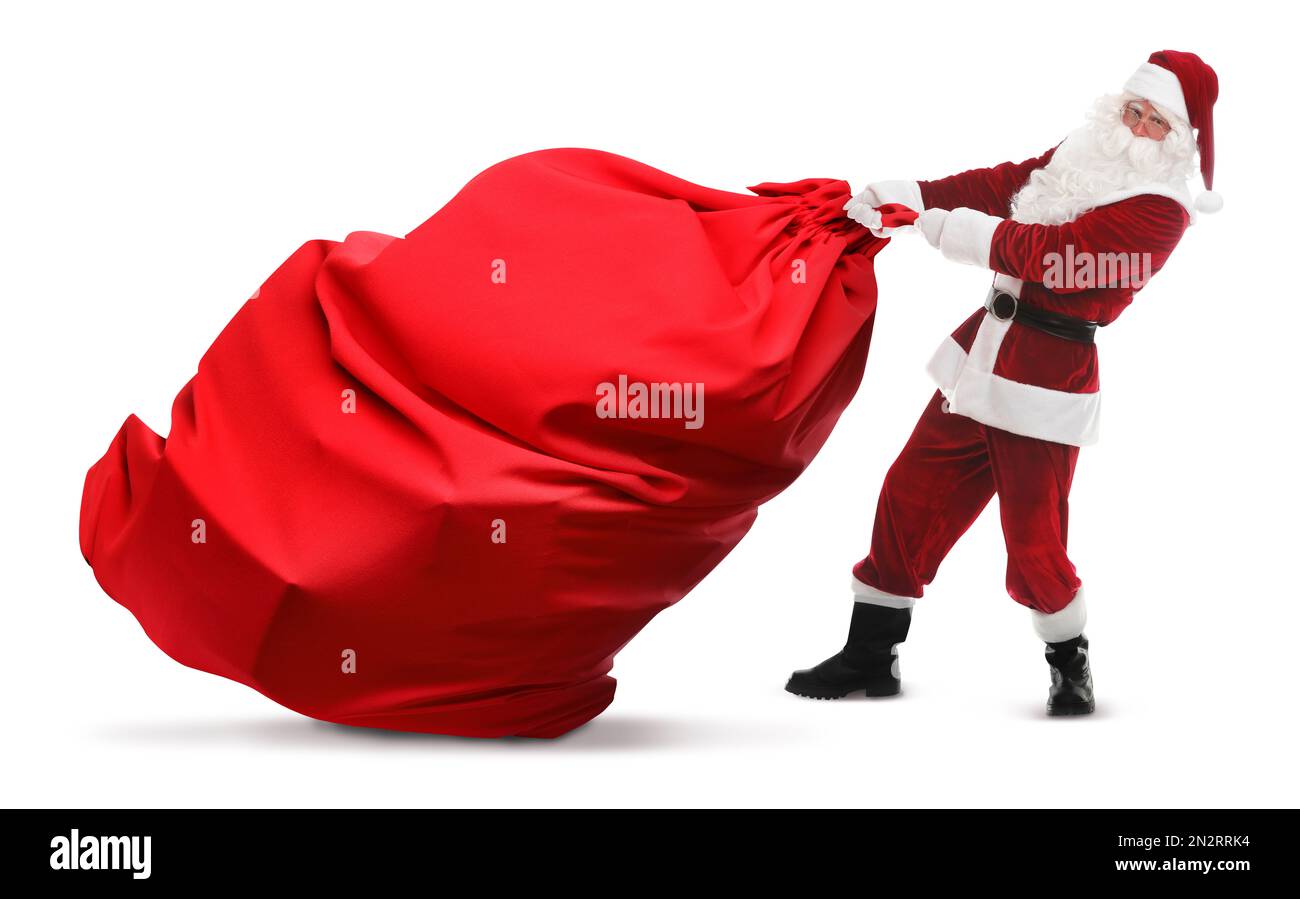 Santa Claus pulling enormous red bag full of Christmas gifts on white ...